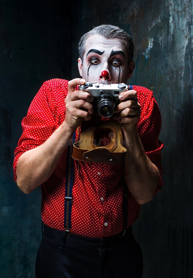 The Scary Clown and a Camera on Dack Background. Halloween Concept ...