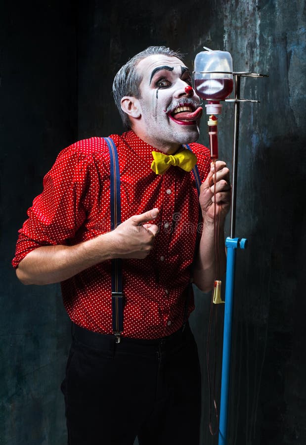 The Scary Clown and Drip with Blood on Dack Background. Halloween ...