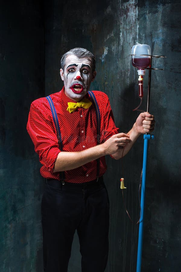 The Scary Clown and Drip with Blood on Dack Background. Halloween ...