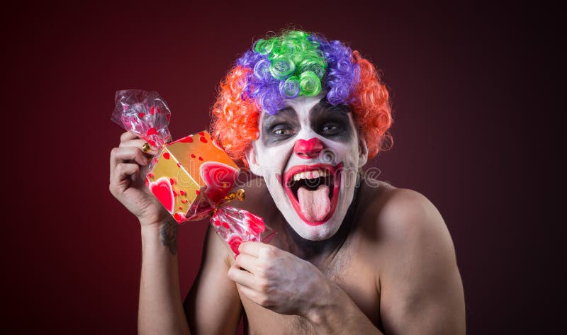 Scary Clown with Spooky Makeup and More Candy Stock Photo - Image of ...