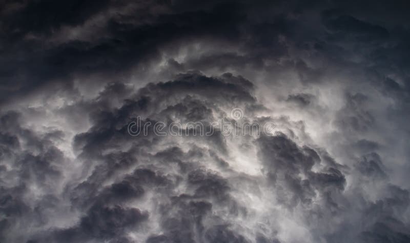 Scary and Dramatic Sky with Light Shining from Dark Cumulus Thunder ...