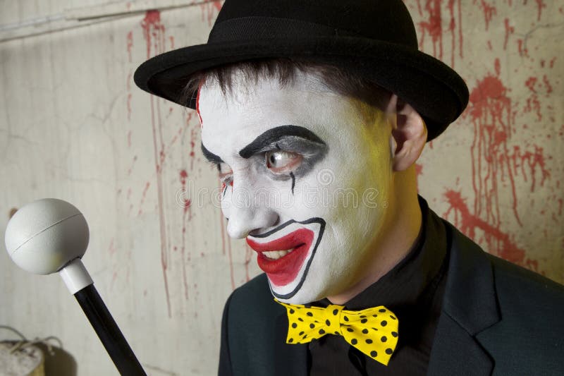 Scary Evil Clown Wearing a Bowler Hat on Wall Stock Photo - Image of ...