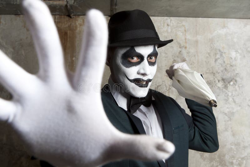 Scary Evil Clown Wearing a Bowler Hat on Wall Stock Photo - Image of ...