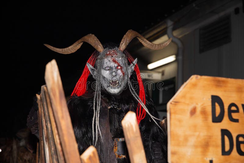 Scary Horned Creature with Red Hair and Fangs on a Dark Night Editorial ...