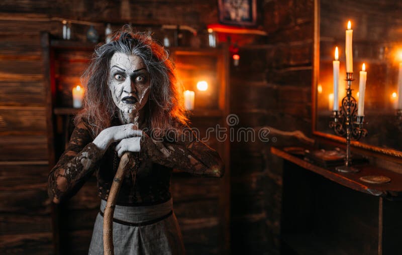 Scary Witch with a Cane at the Mirror and Candles Stock Photo - Image ...