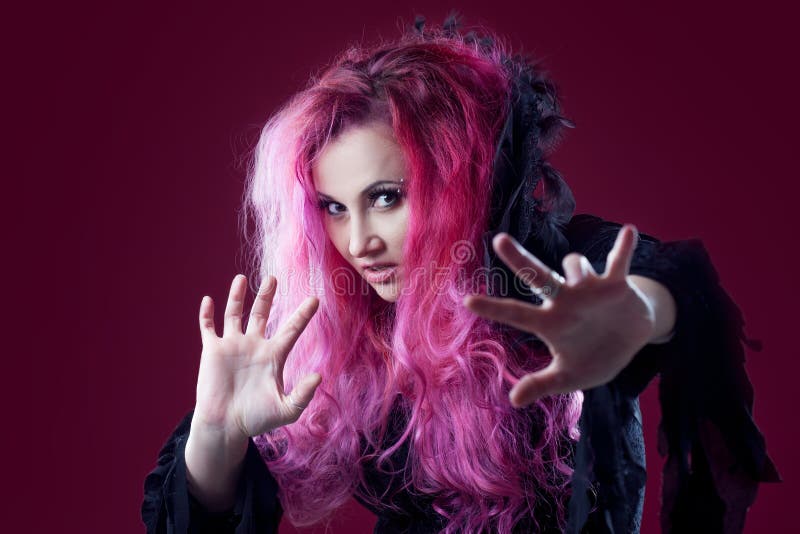 Scary Witch with Red Hair Performs Magic. Halloween. Stock Photo ...
