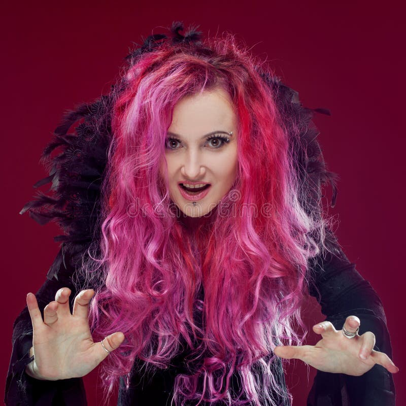 Scary Witch with Red Hair Performs Magic. ?reate Something with Hands ...