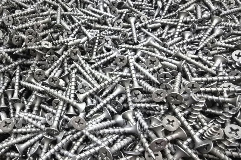Scattered Collection of Metallic Screws on a Work Surface Stock Photo ...