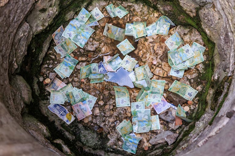 Scattered Currency Notes in a Water-filled Stone Well Stock Image ...