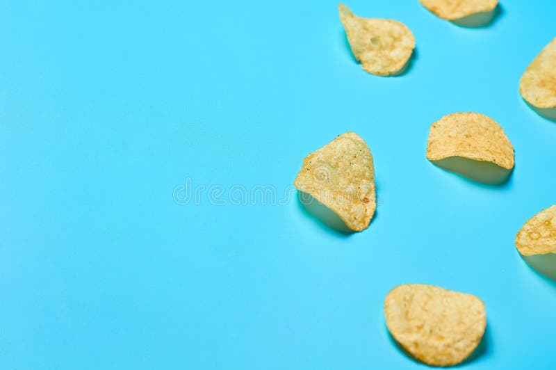 Scattered Fried Potato Chips on Blue Background Stock Photo - Image of ...