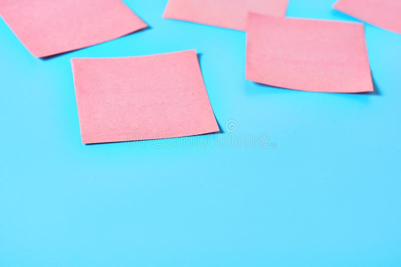 Scattered Many Pink Square Blank Paper Stickers on Blue Background ...