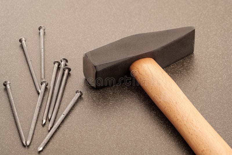 Scattered Nails and a Hammer on a Ceramic Surface Stock Photo - Image ...