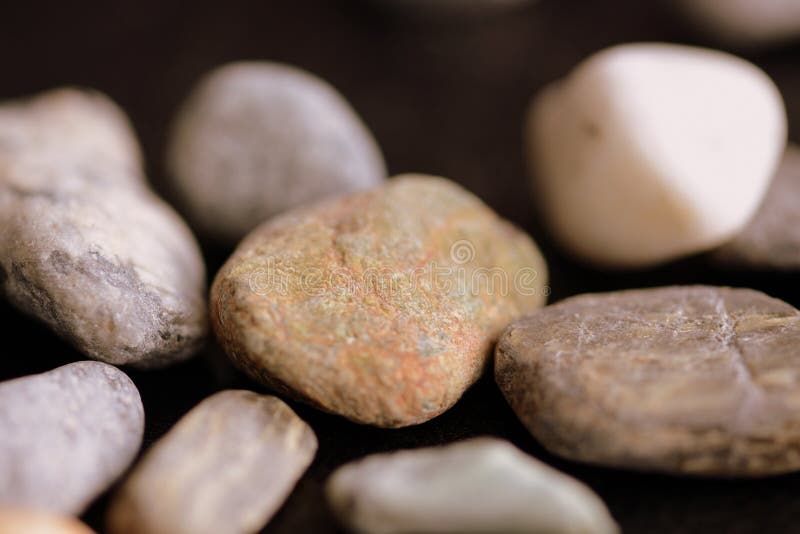 Scattered Pebble Stones on a Dark Background Stock Photo - Image of ...