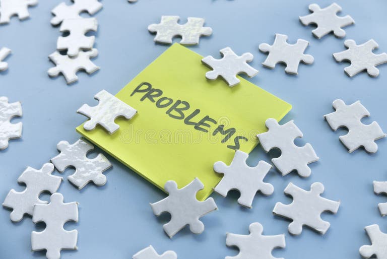 Scattered Puzzle Pieces with Yellow Sticky Note Reading "Problems" on ...