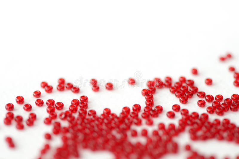 Scattered Seed Beads Red Color on a White Surface Stock Photo - Image ...