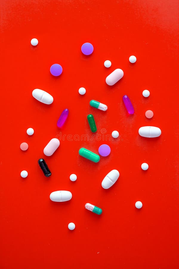 Scattered Various Colored Tablets in a Red Background. View from Above ...