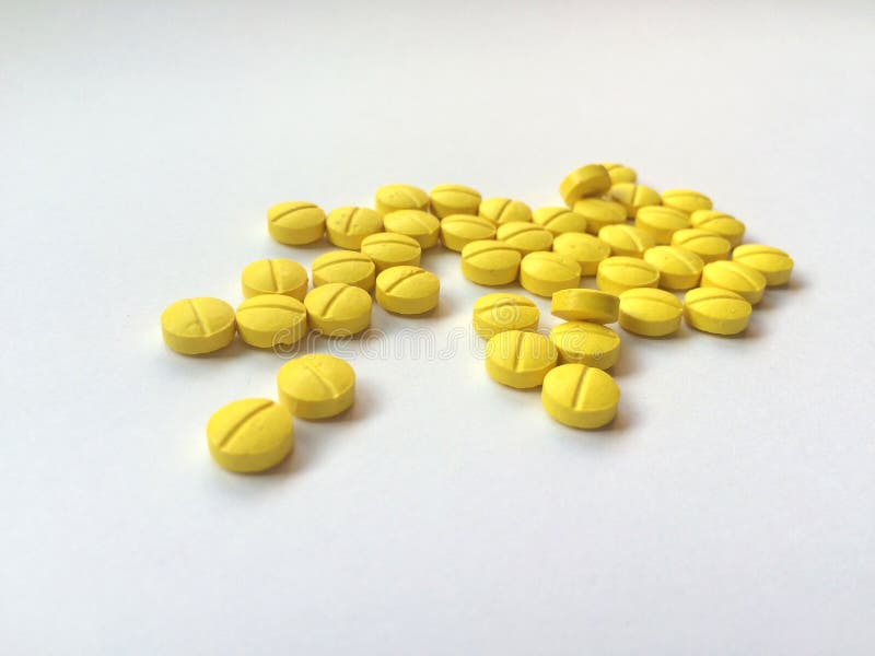 Scattered yellow pills stock photo. Image of medical - 73167152