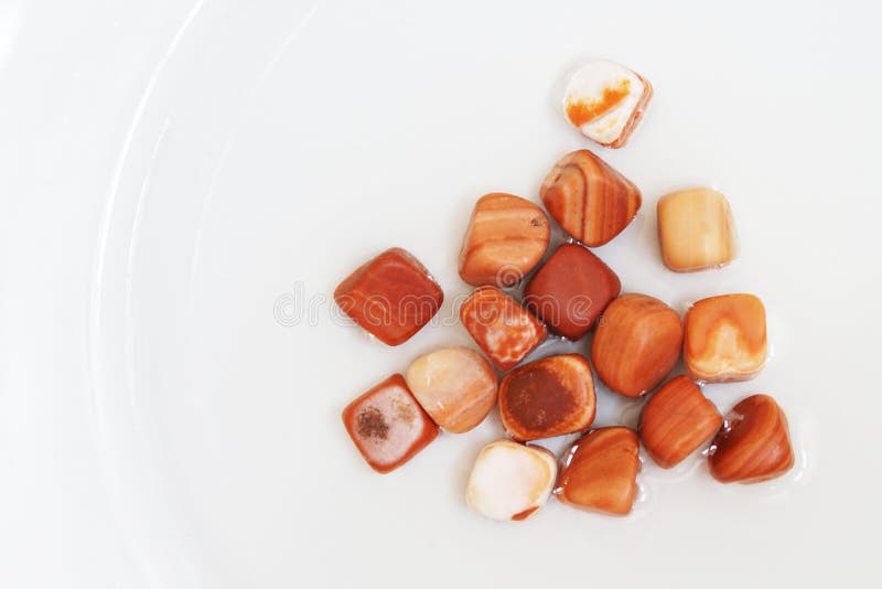 A Scattering of Beautiful Smooth Natural Stones. Flint on a White ...