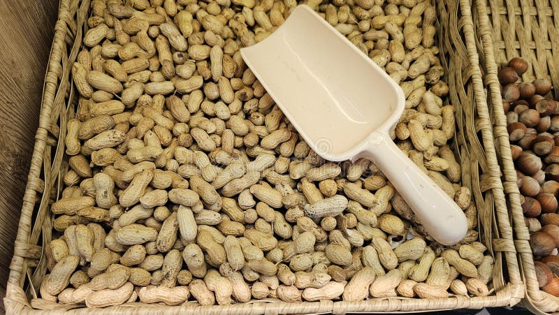 A Scattering of Peanuts and a Scoop on the Counter of a Vegetable Store ...