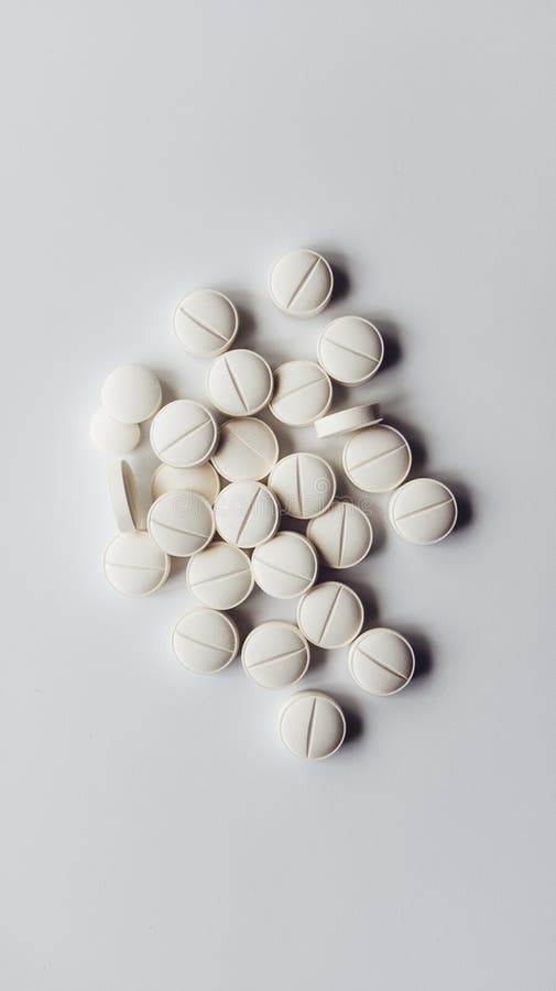 White Tablets Scattered on Plain Surface, Highlighting Minimalistic ...