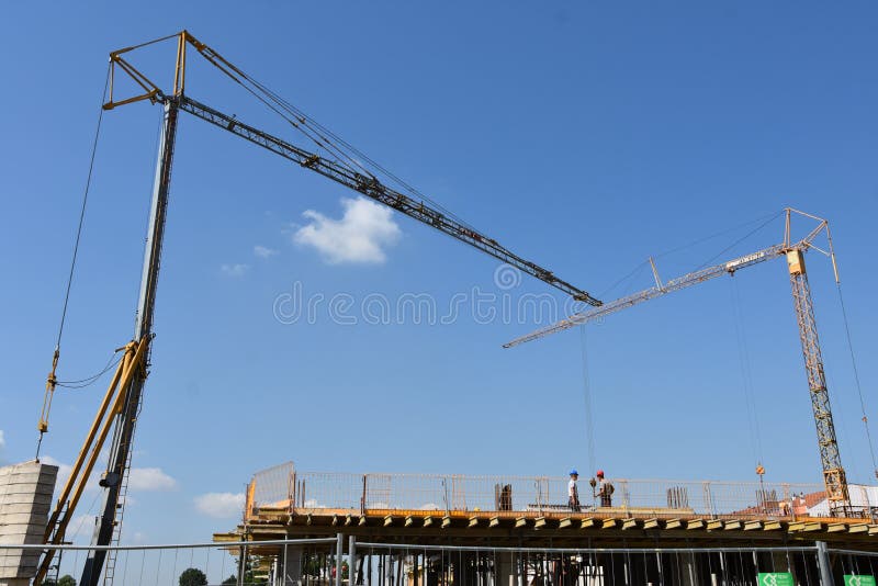 Scene of Crane at Building Construction Site with Workers on Buliding ...