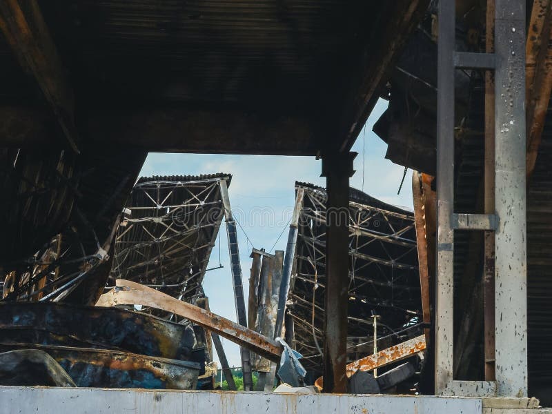A Scene of Destruction with Collapsed Metal Structures and Fire Damage ...