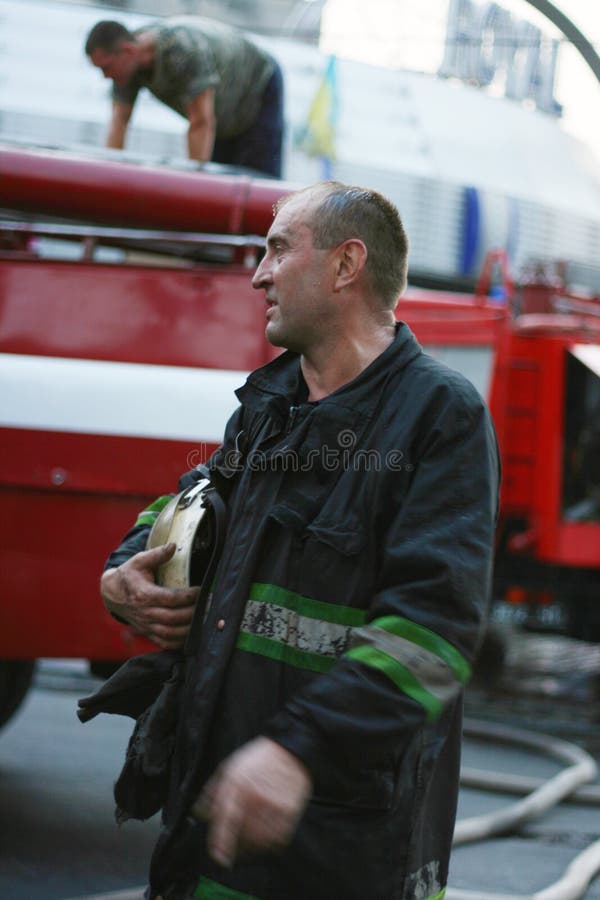 At the Scene of a Fire in a Building. Firefighters Work Concept ...