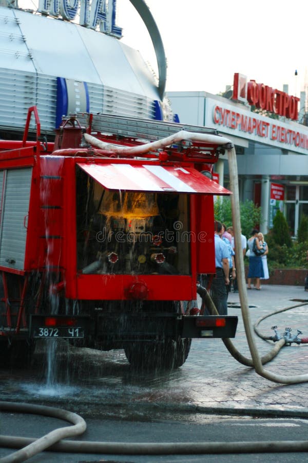 At the Scene of a Fire in a Building. Firefighters Work Concept ...