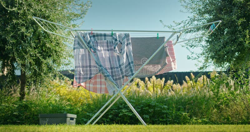 Clothes Drying on a Foldable Laundry Rack in a Sunny Backyard. Stock ...