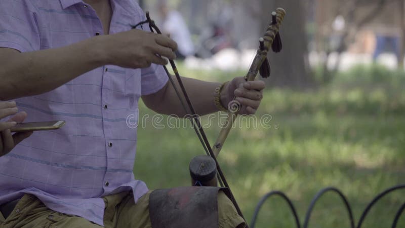 Man Playing a Chinese Two Stringed Fiddle Stock Video - Video of hand ...
