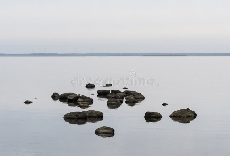 Rocks on calm waters stock image. Image of beach, cloud - 26861779
