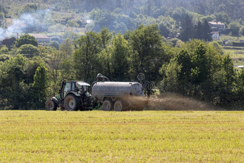 Tractor in a Crop Field Spreading Liquid Manure Stock Image - Image of ...