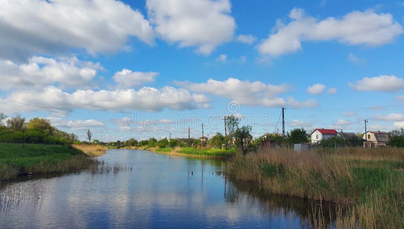 The Scenery of the Countryside. River, Sky, Clouds, Houses Stock Photo ...