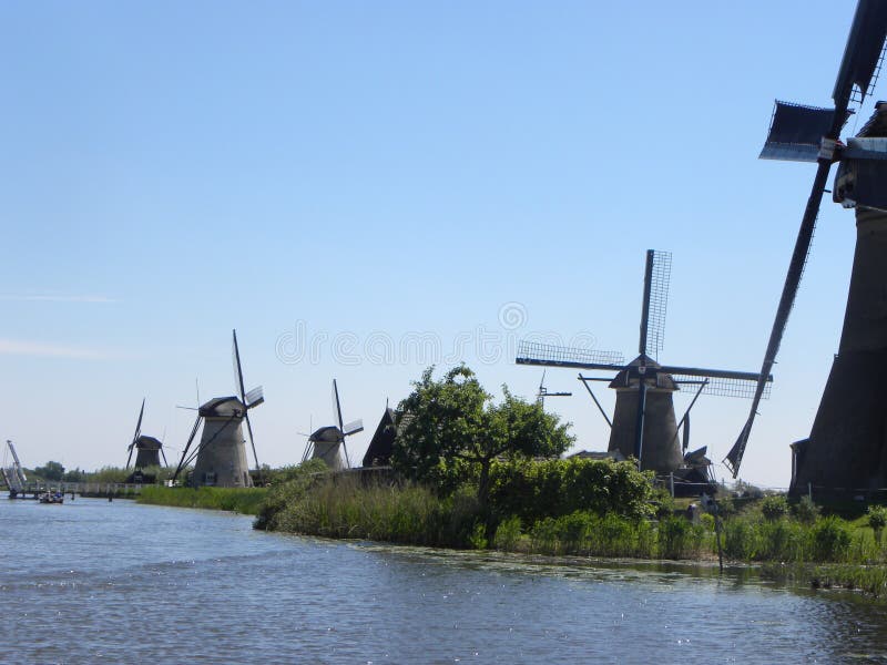 Scenery of Mills Near a River on a Blue Clear Sky Background Stock ...