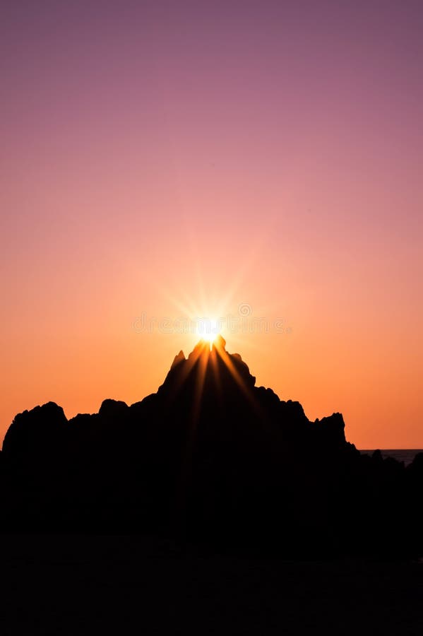 Scenery of the Setting Sun Overlapping the Rocks and the Sky Dyed Red ...