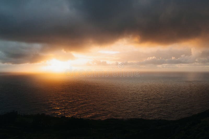 Scenery Shot of Sunset with a Gloomy Sky in the Ocean Stock Photo ...