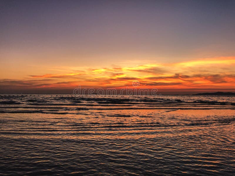 Scenery of Sunset on the Beach with Calming Waves of the Ocean Stock ...