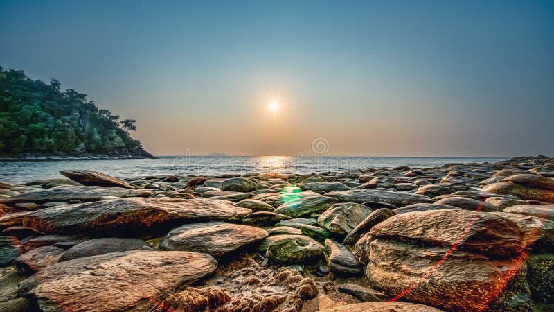 Sunset at rocky beach stock image. Image of cloud, beautiful - 142596817