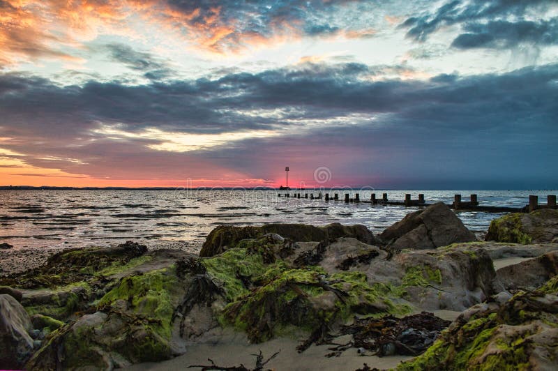 Scenic Beach with Big Rocks during a Dramatic Sunset Stock Image ...