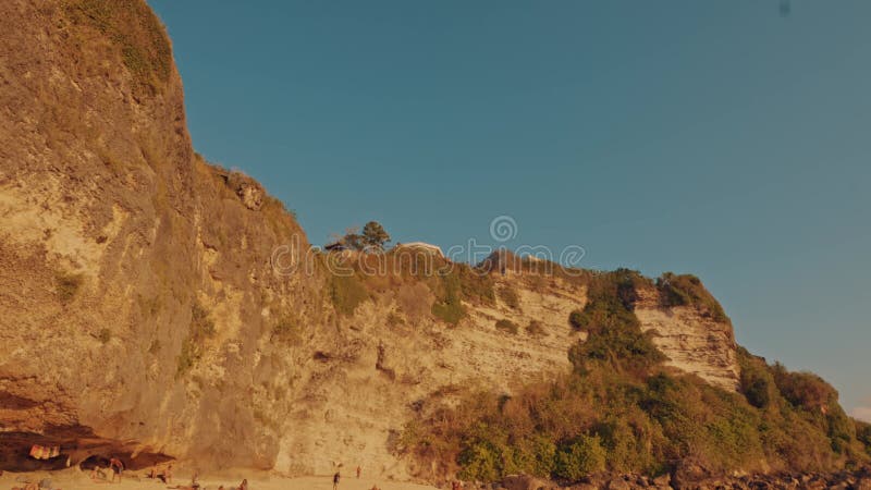 Scenic Beach with Towering Cliffs at Sunset Stock Video - Video of ...