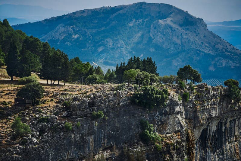 Scenic Cliffs and Forested Landscape with Distant Mountains Under a ...