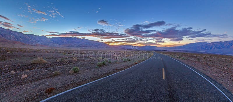 Scenic Desert Road at Sunset with Colorful Clouds and Mountain Backdrop ...