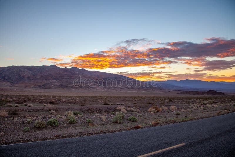 Scenic Desert Road at Sunset with Colorful Clouds and Mountain Backdrop ...