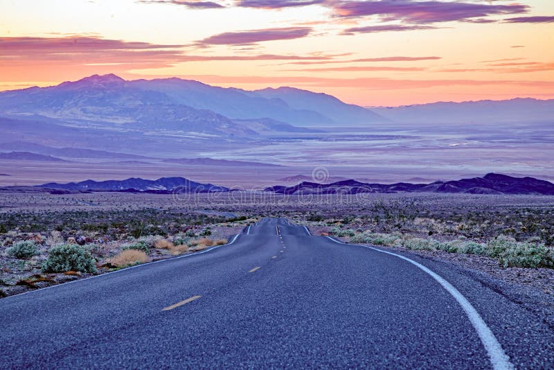 Scenic Desert Road at Sunset with Colorful Clouds and Mountain Backdrop ...