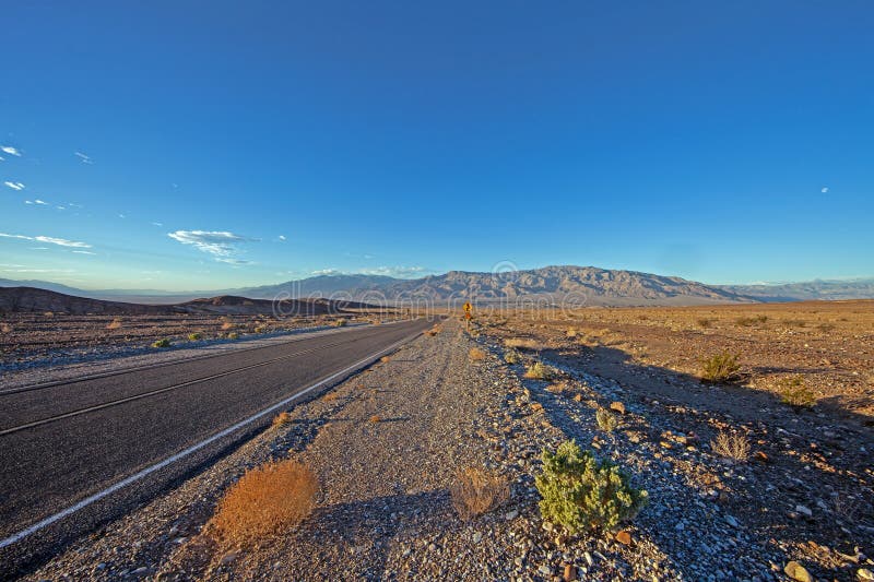 Scenic Desert Road at Sunset with Colorful Clouds and Mountain Backdrop ...