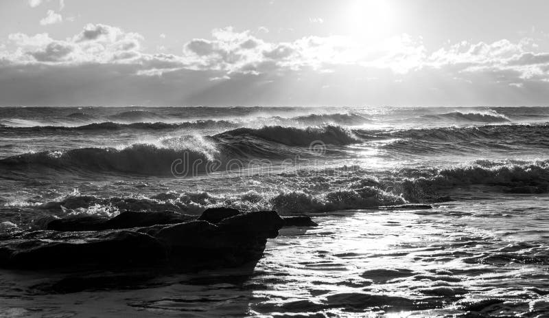 Scenic Grayscale View of Ocean Waves Reaching the Shore at Sunset Stock ...