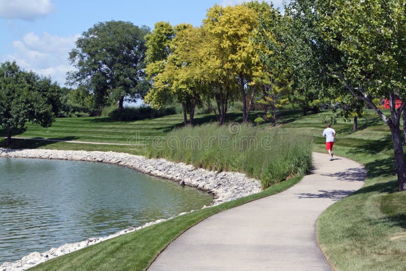Scenic Jogging Path with Runner Stock Photo - Image of plant, estate ...