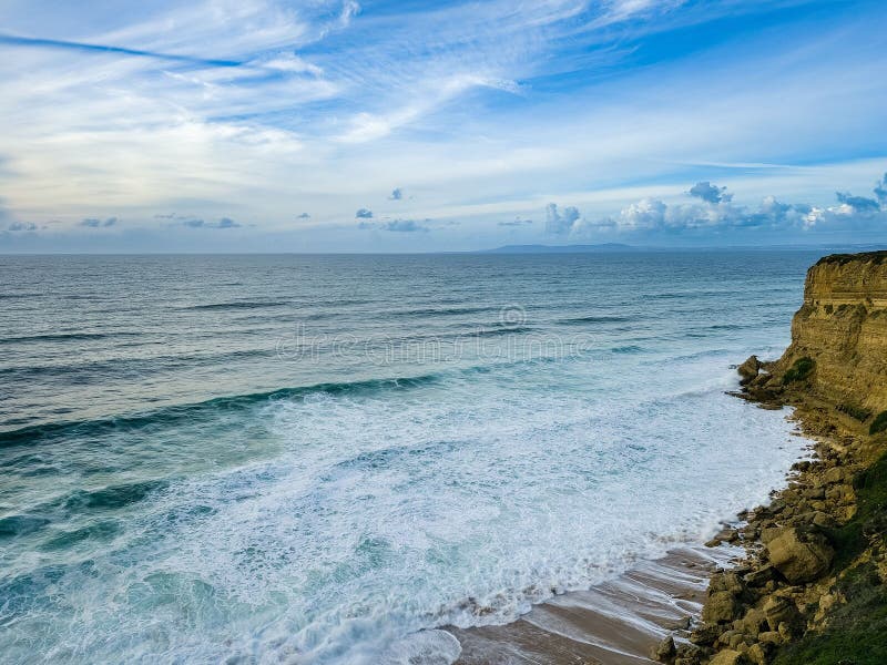 The Cliffs Overlooking the Ocean at Sunrise with Waves in Foreground ...