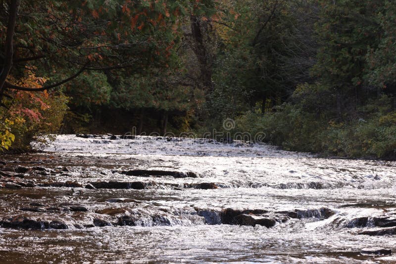 Scenic Landscape Featuring a Large Waterfall Cascading Down a Rocky ...