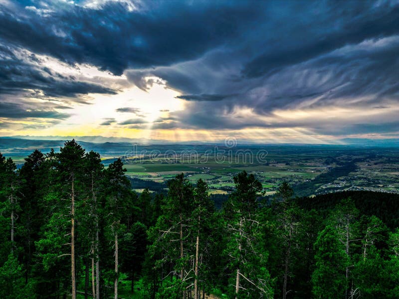 Scenic Landscape Featuring a Sunbeam Breaking through a Cloudy Sky with ...